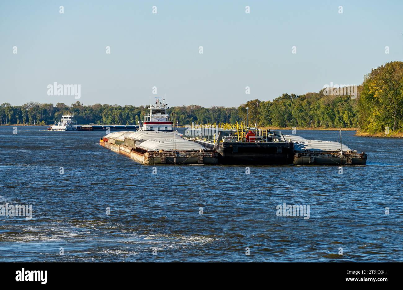 Two large tug boats pushing rows of barges with grain and petroleum ...