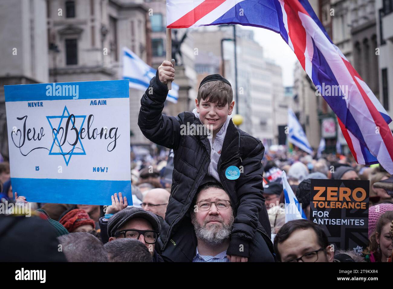 London, UK. 26th November 2023. A young Jewish boy sits on his fathers ...