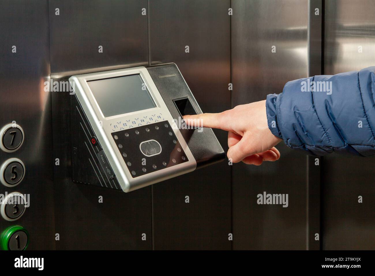 The man put his finger in the Fingerprint Access Control Terminal with ...