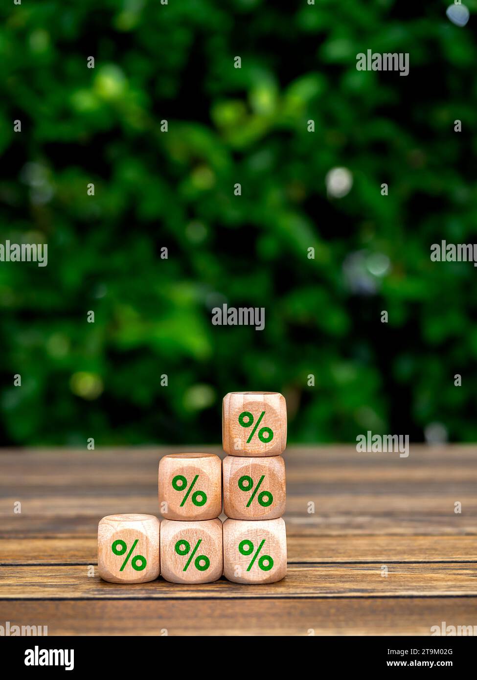 Green percentage icon on wooden cube blocks build as business chart ...