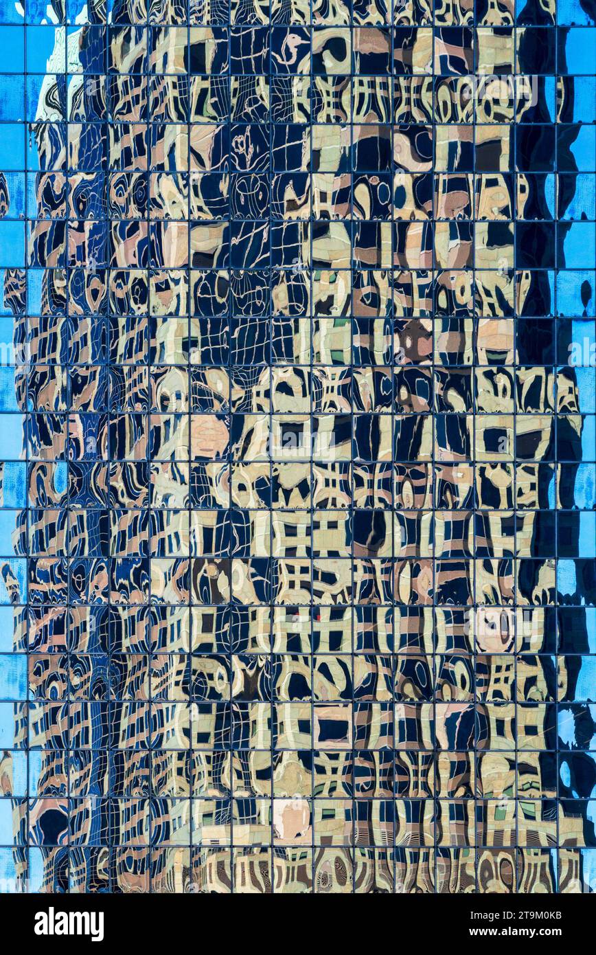 Reflections of a modern office skyscraper in a mirrored building in ...