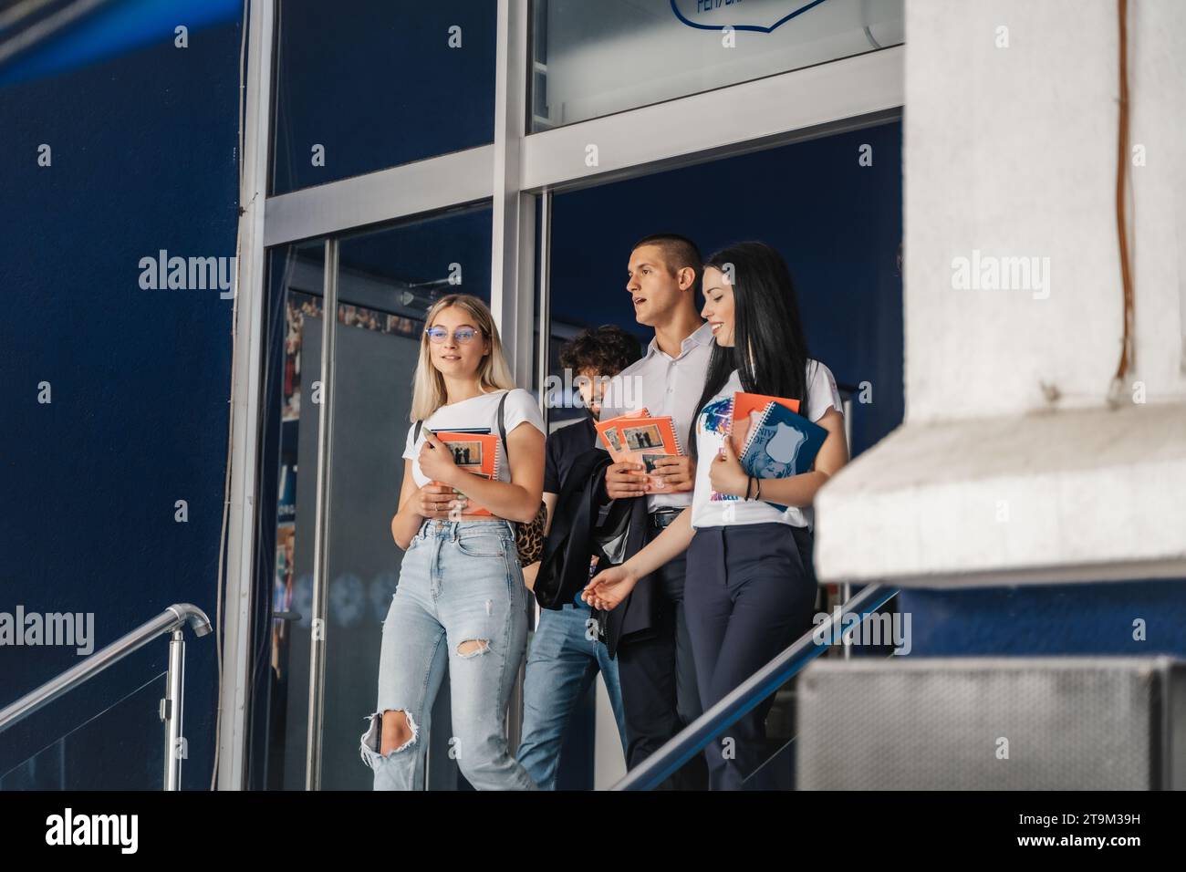 A diverse group of university students engaged in a happy, successful ...