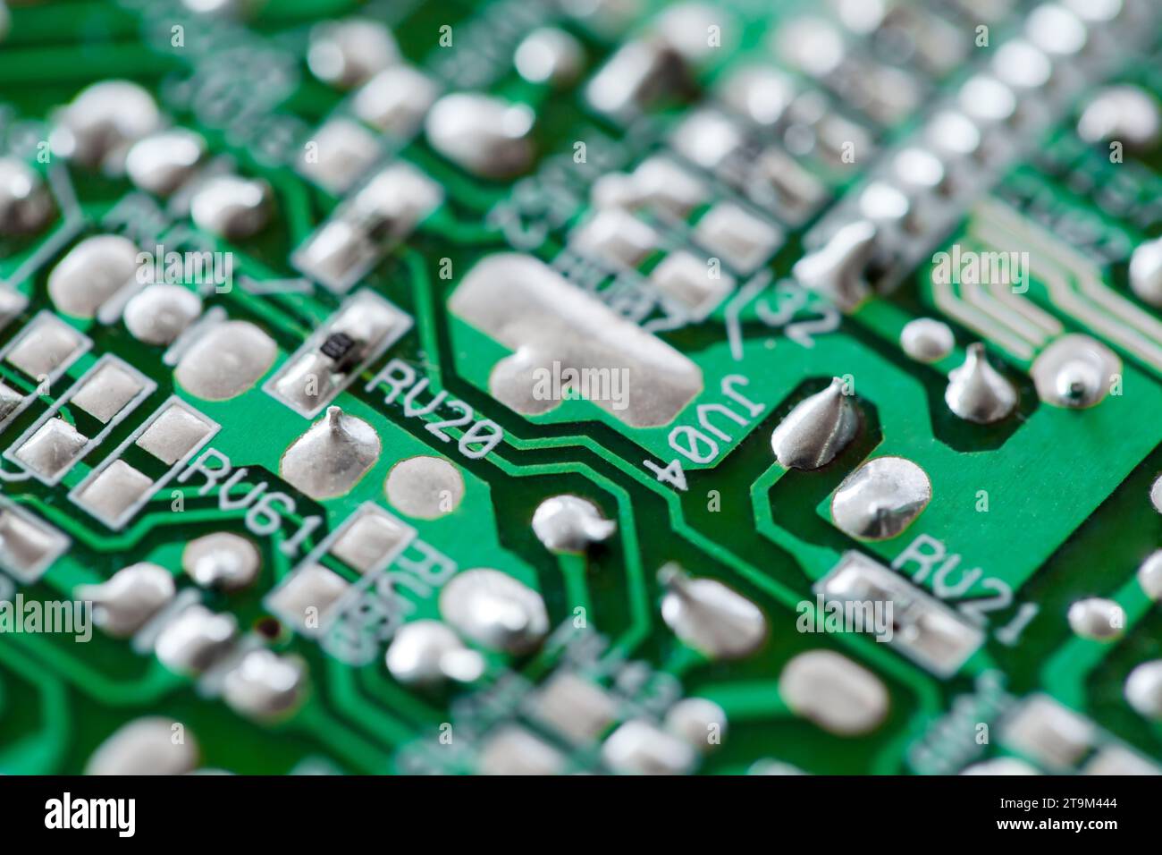 Electronic printed circuit board green with copper tracks, macro close ...