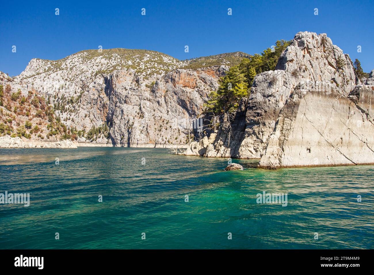 Landscape of lake with turquoise water and stone sharp rocks walls ...