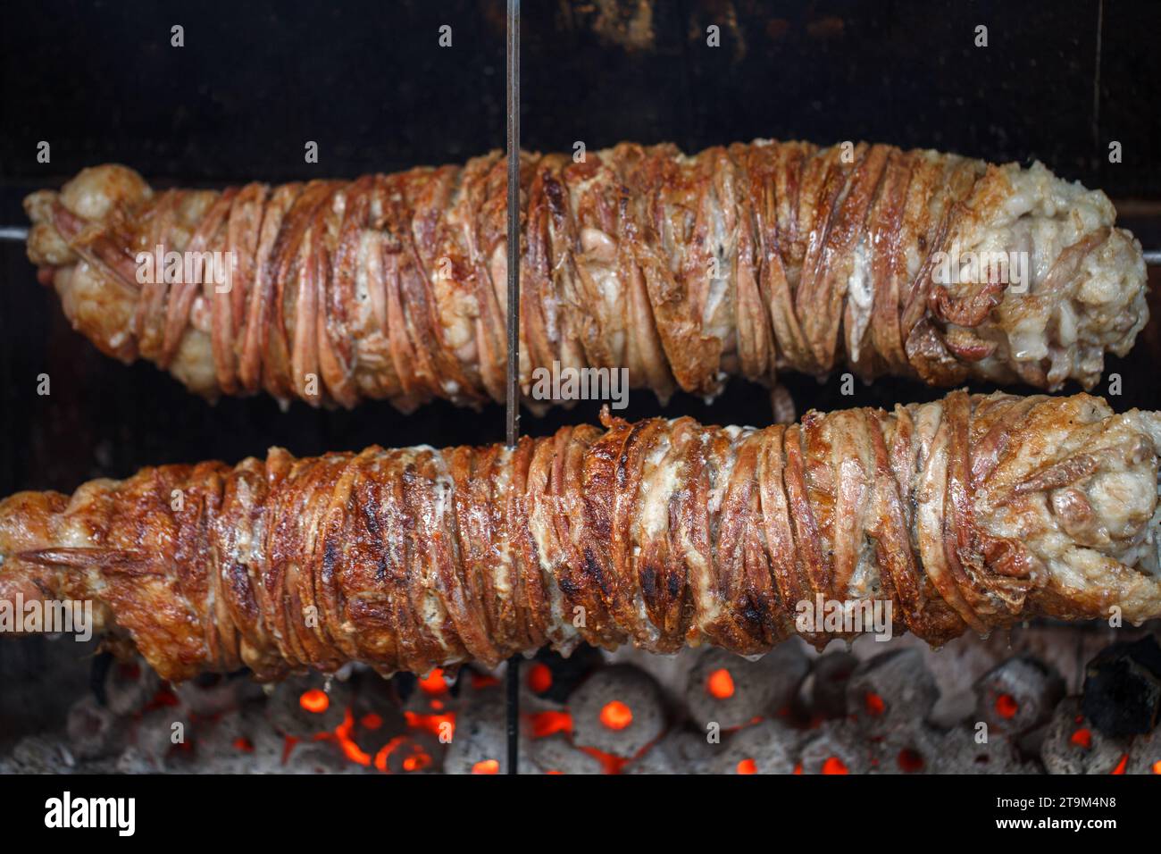 Lamb intestines and giblets spun on spit and fried for Turkish dish ...