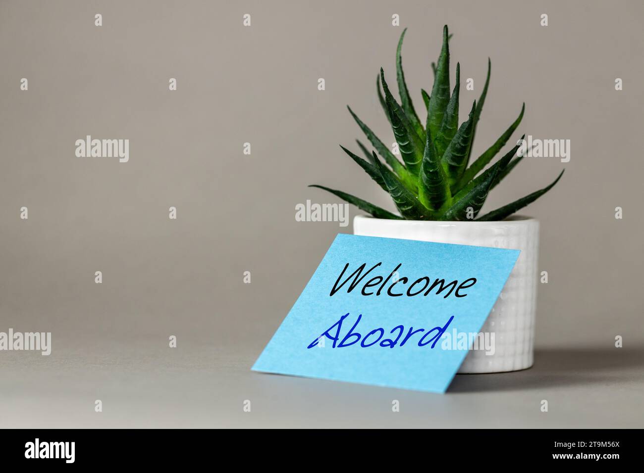 Welcome aboard, words written on a blue card and left on the desk with ...