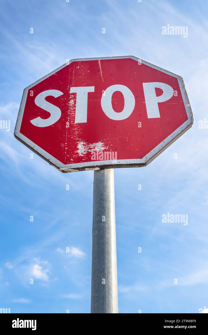 Stop sign against a blue sky with white clouds. Bottom view Stock Photo ...