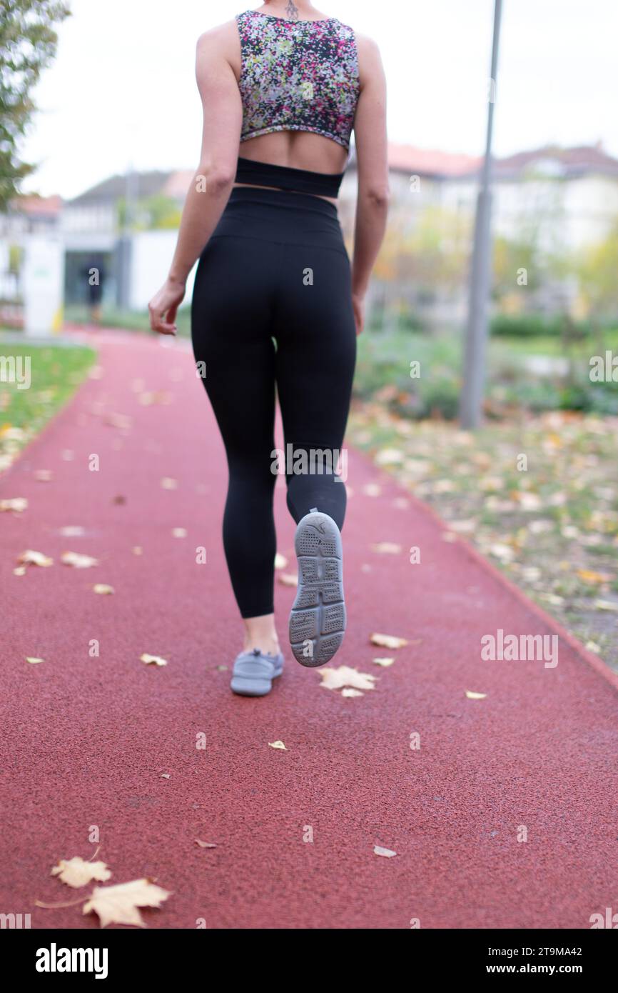 Back view woman jogging in hi-res stock photography and images - Alamy