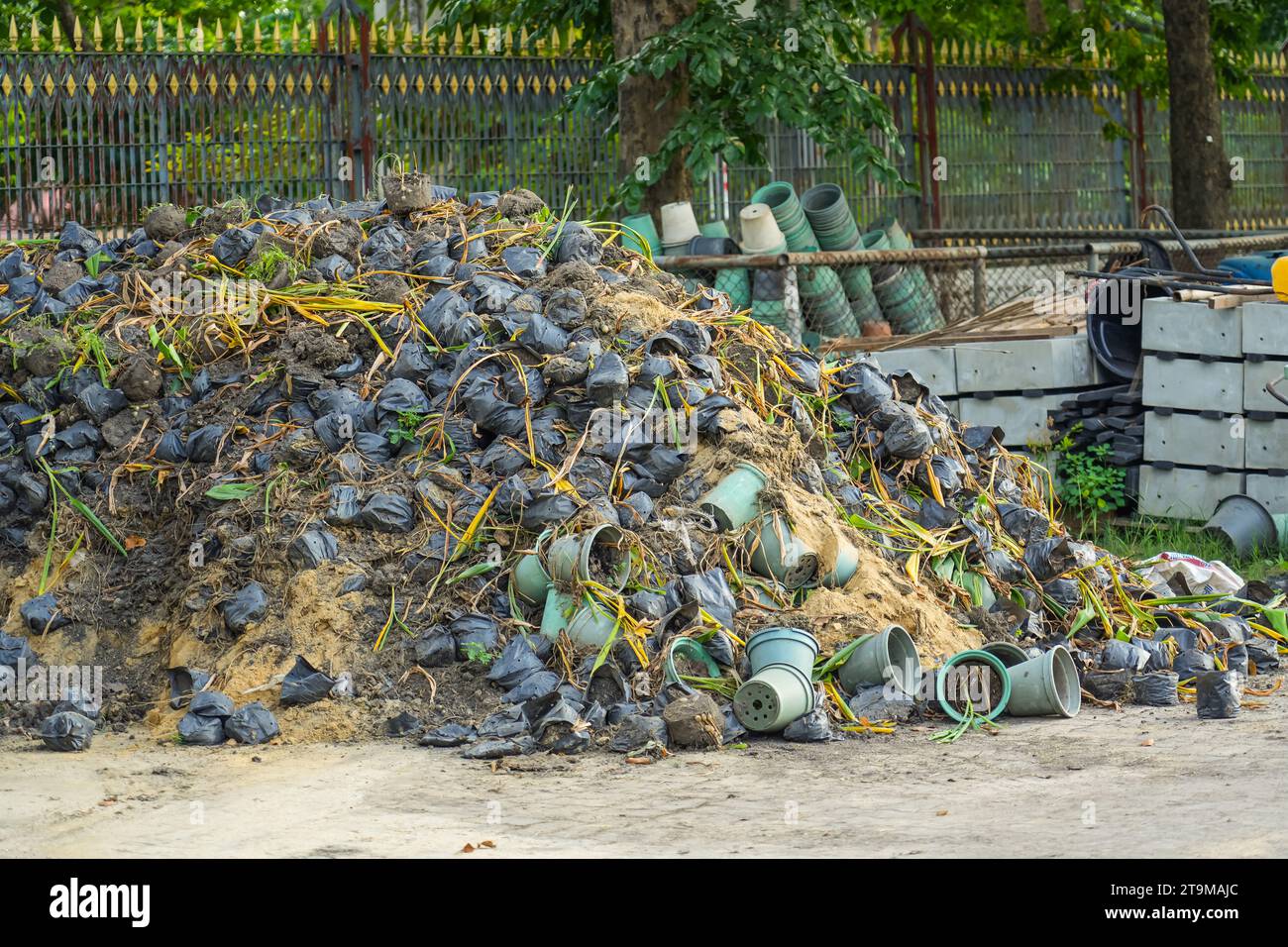 Heap of waste garbage dump with pots and leaves of dried plants in ...
