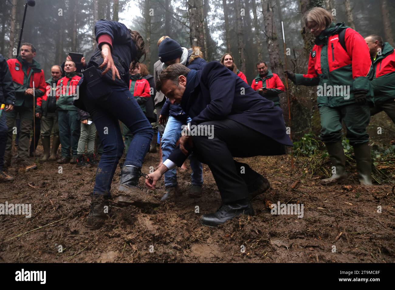French President Emmanuel Macron plants a tree during his visit at the ...