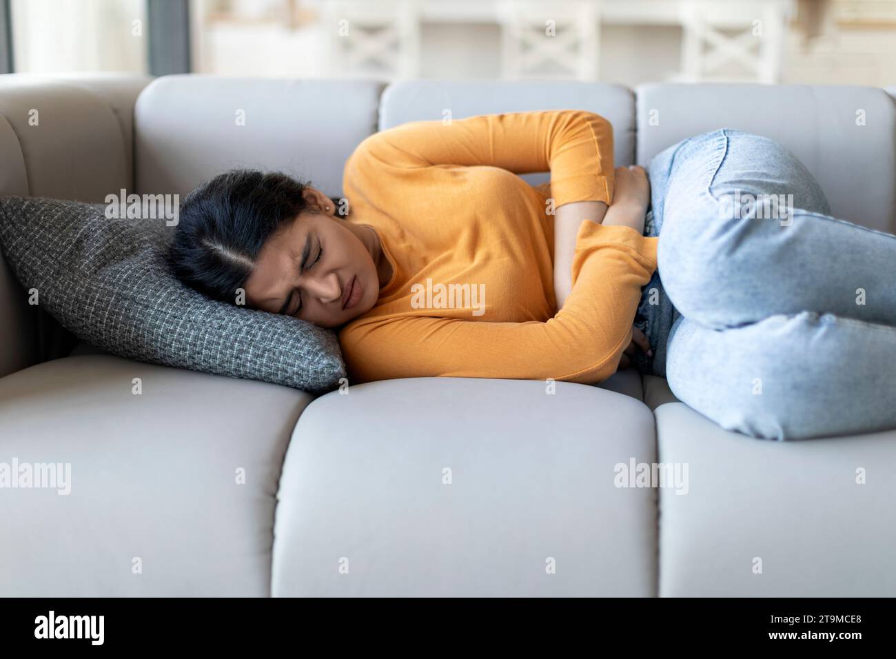 Stomach Ache. Sick Young Indian Female Suffering From Abdominal Pain At ...