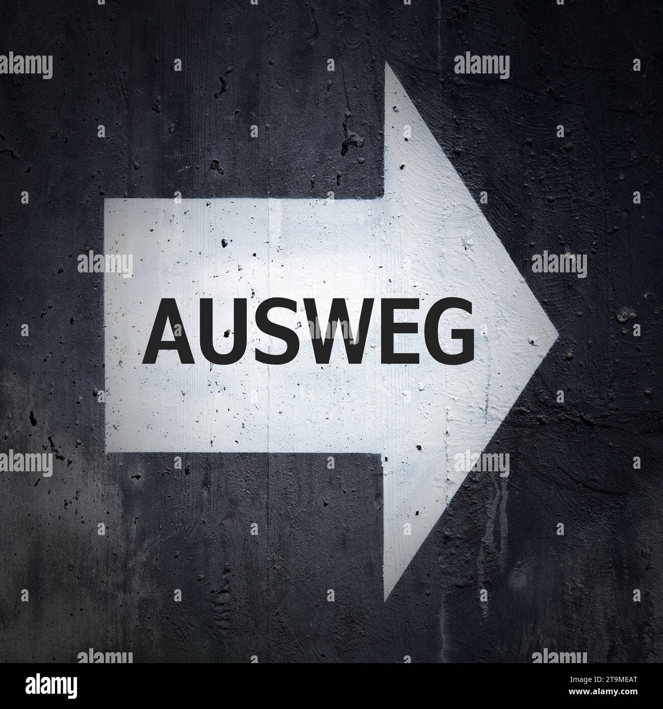 white directional arrow on a concrete wall with the German inscription ...