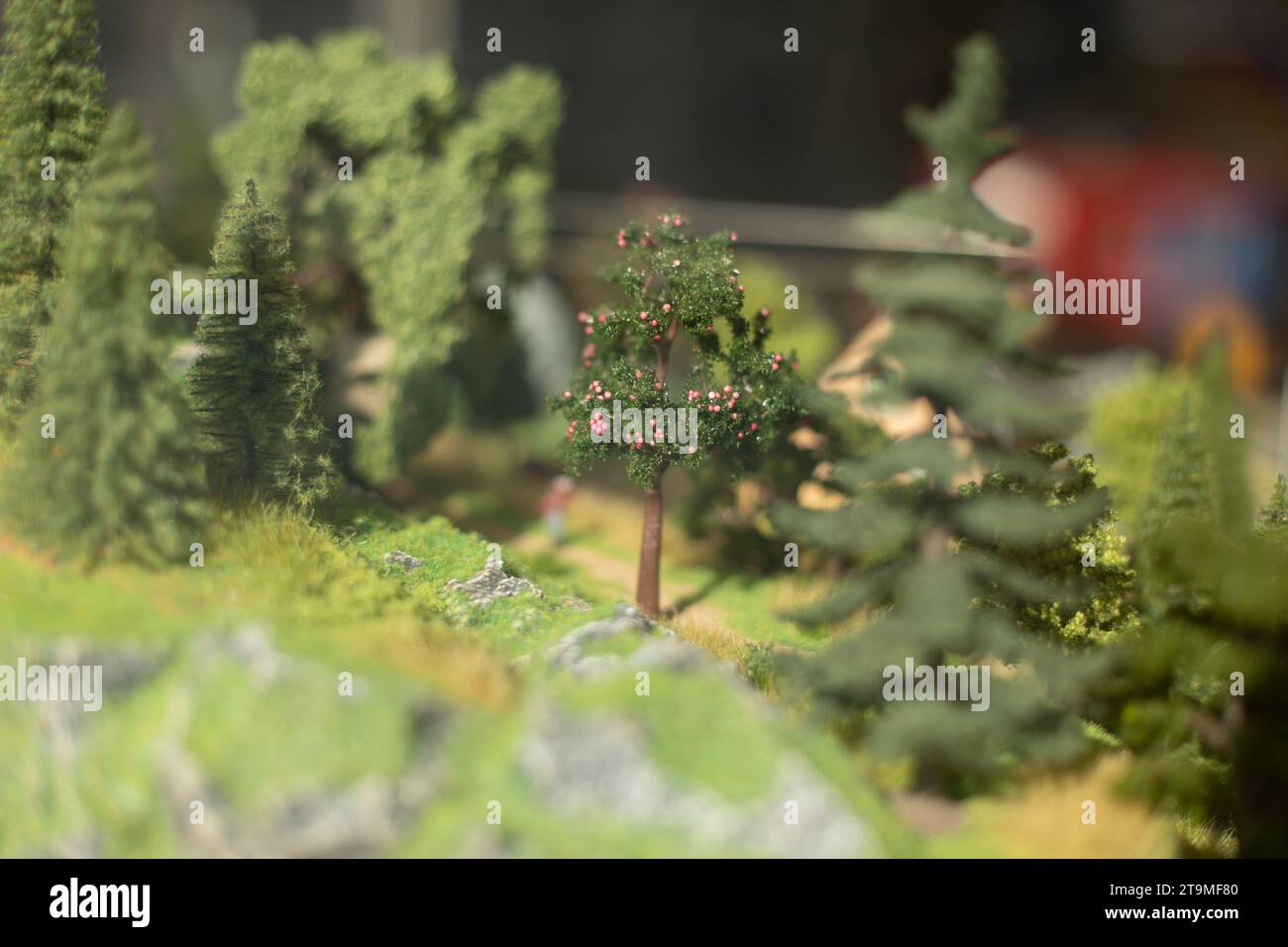 Model of mountainous area. Miniature trees in toy park. Mountain ...