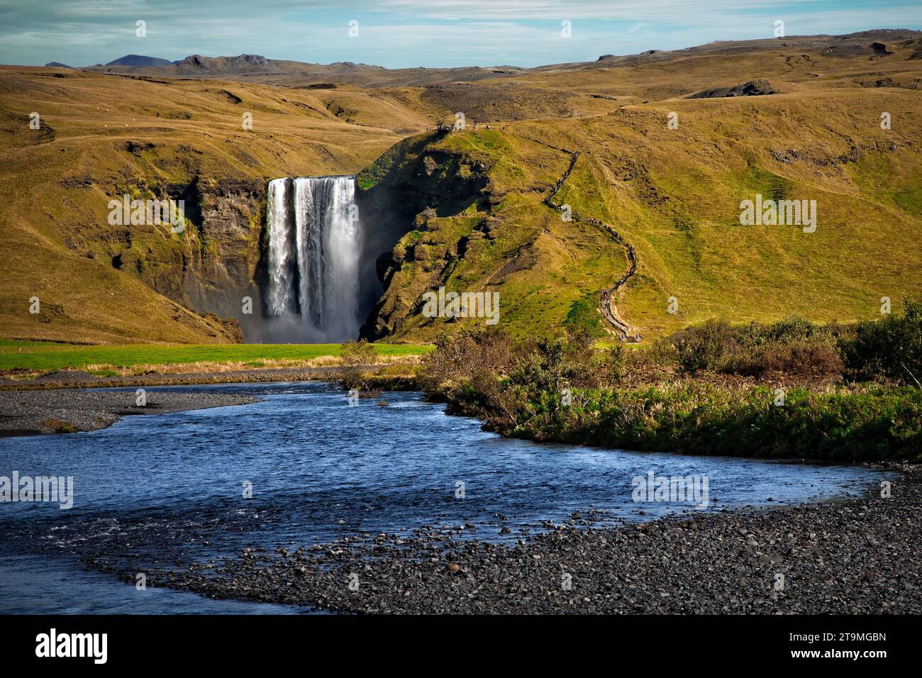 Vistors march the steps to the top of Skogafoss, a waterfall on the ...