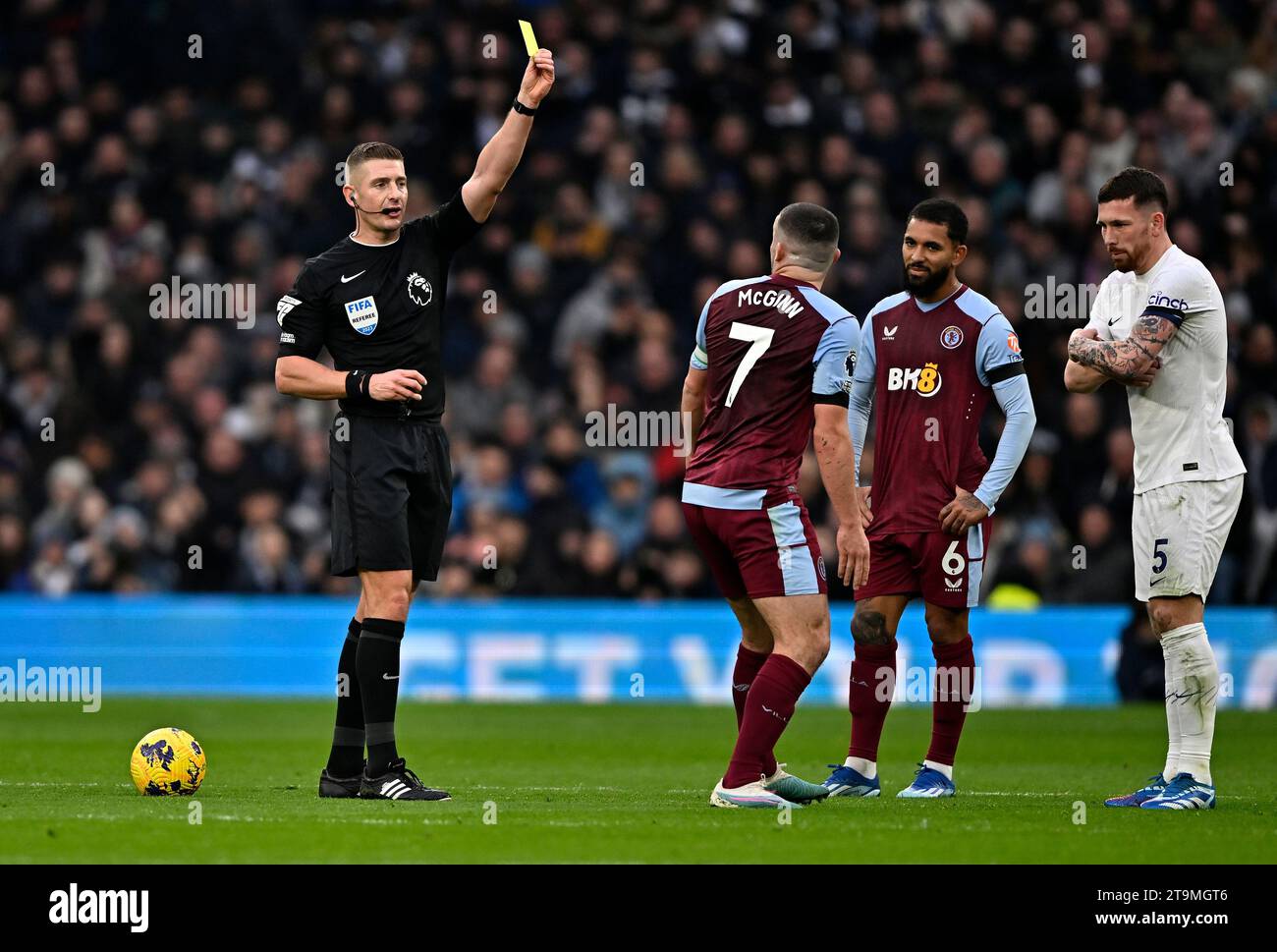 London, UK. 26th Nov, 2023. Rob Jones (Referee) shows the yellow card ...