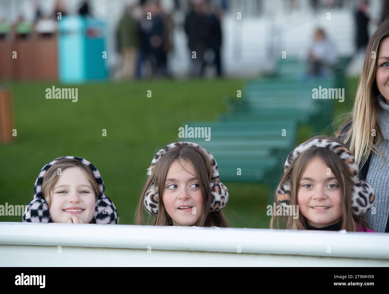 Ascot, Berkshire, UK. 25th November, 2023. Young racegoers wearing ear ...