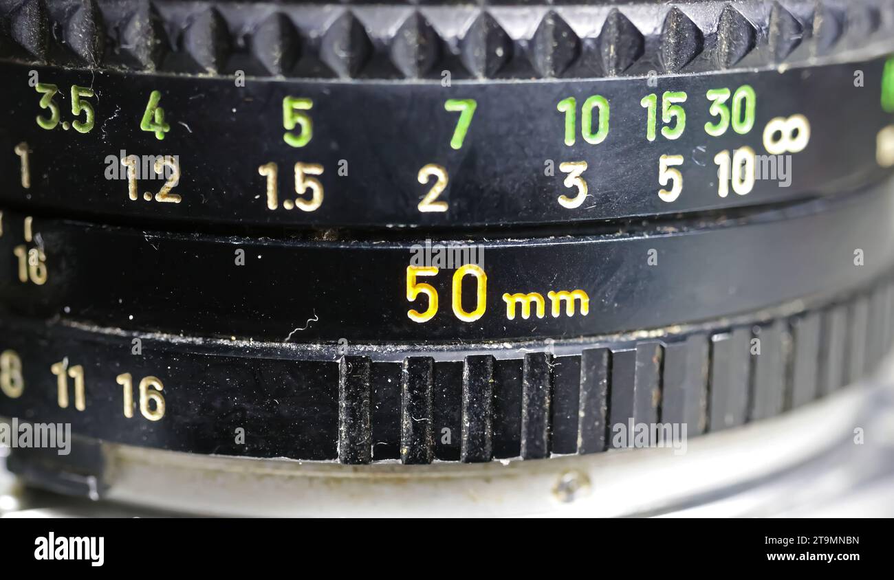 Closeup of old scratched black 50 mm lens with aperture and focal ...