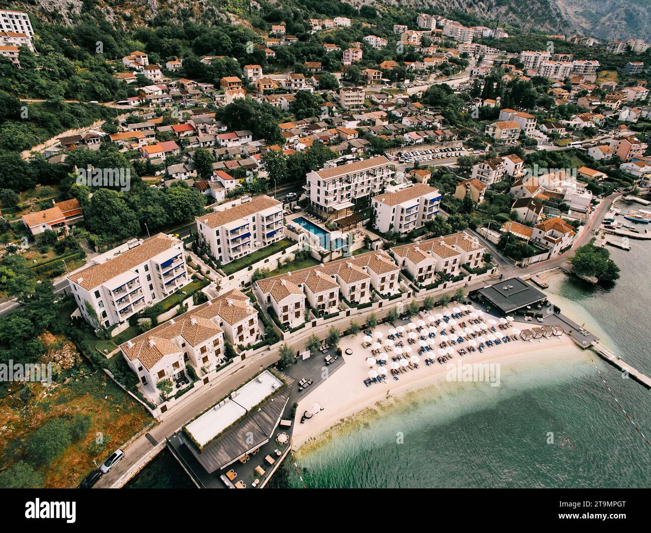 Private beach with sun umbrellas near the Huma Kotor Bay Hotel. Dobrota ...