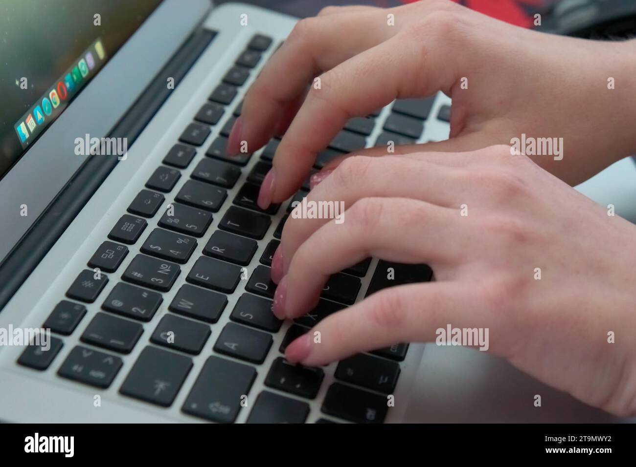 Woman typing on laptop keyboard, hands on keyboard close up, floating ...