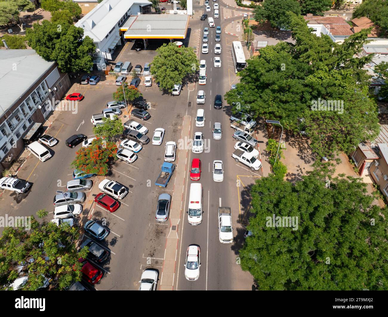 aerial view of car traffic on busy street, a residential area in the ...