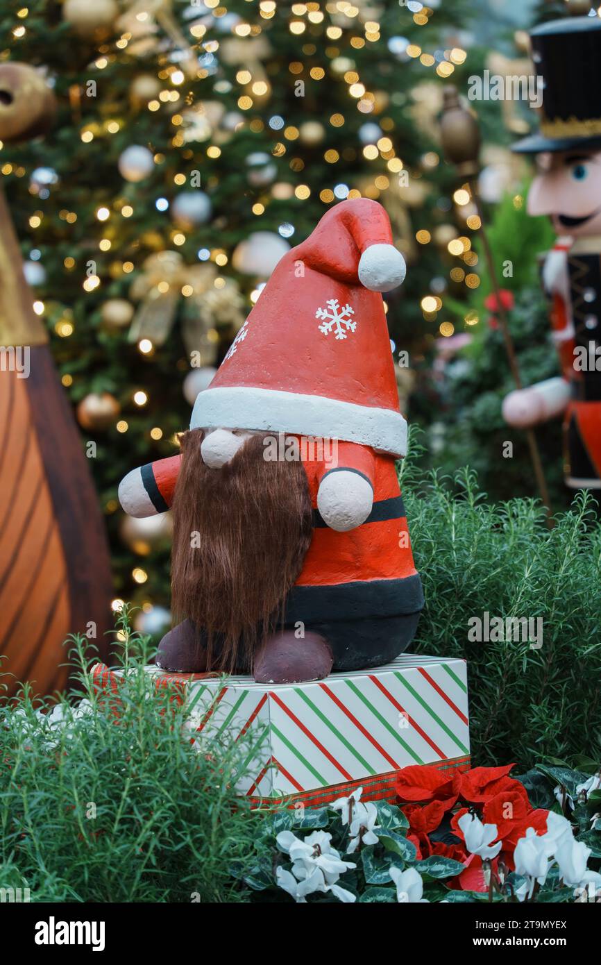 A statue featuring intricate designs with small gnomes and boxes atop ...