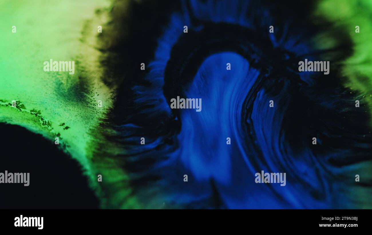 Paint drop ink mix in water green blue fluid blend Stock Photo - Alamy