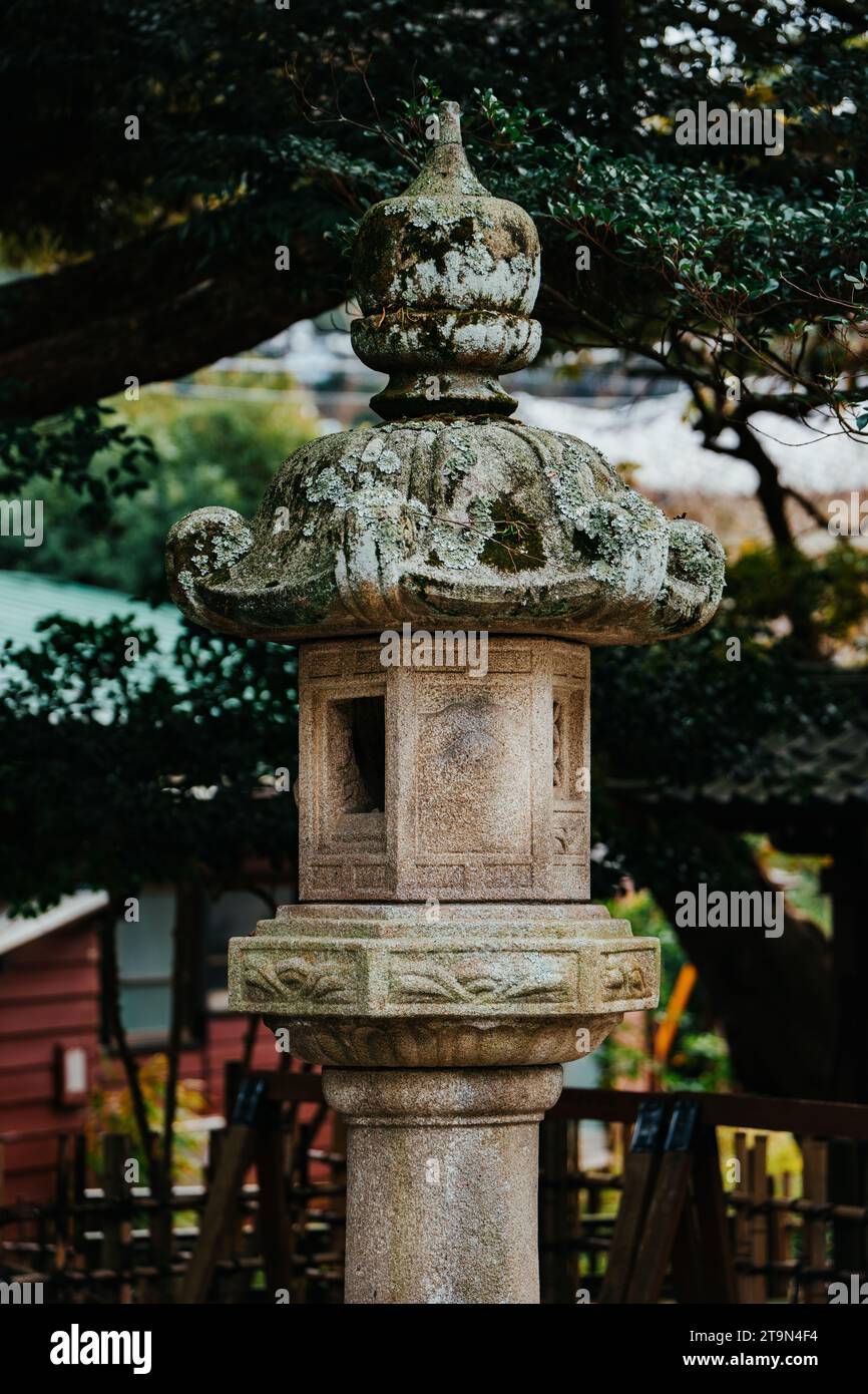 A Japanese Ishi-doro stone lantern in Japan and trees in the background ...