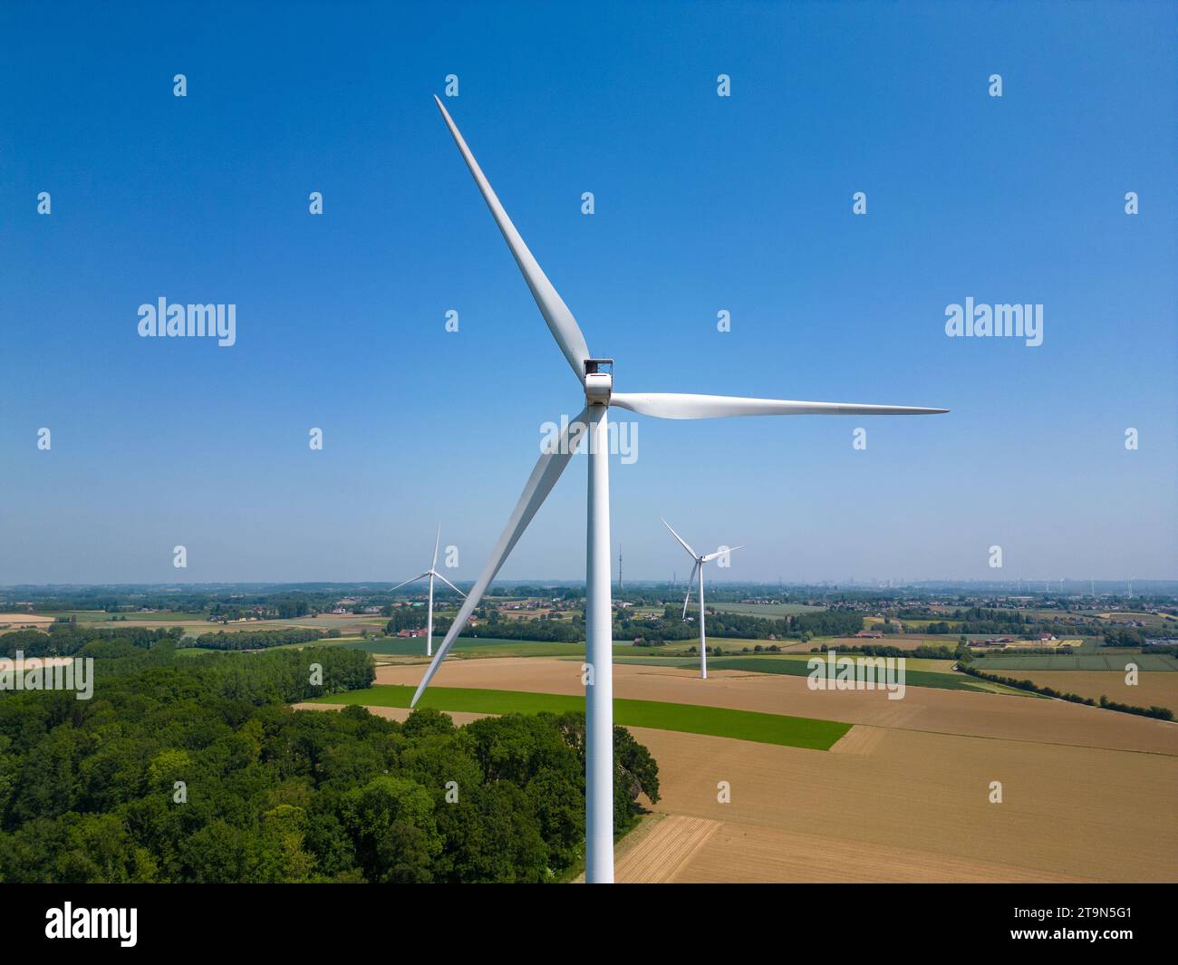 The photograph showcases a majestic wind turbine dominating the rural ...