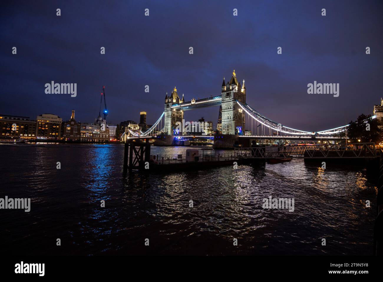 Tower Bridge spanning the Thames as the night draws in on a November ...