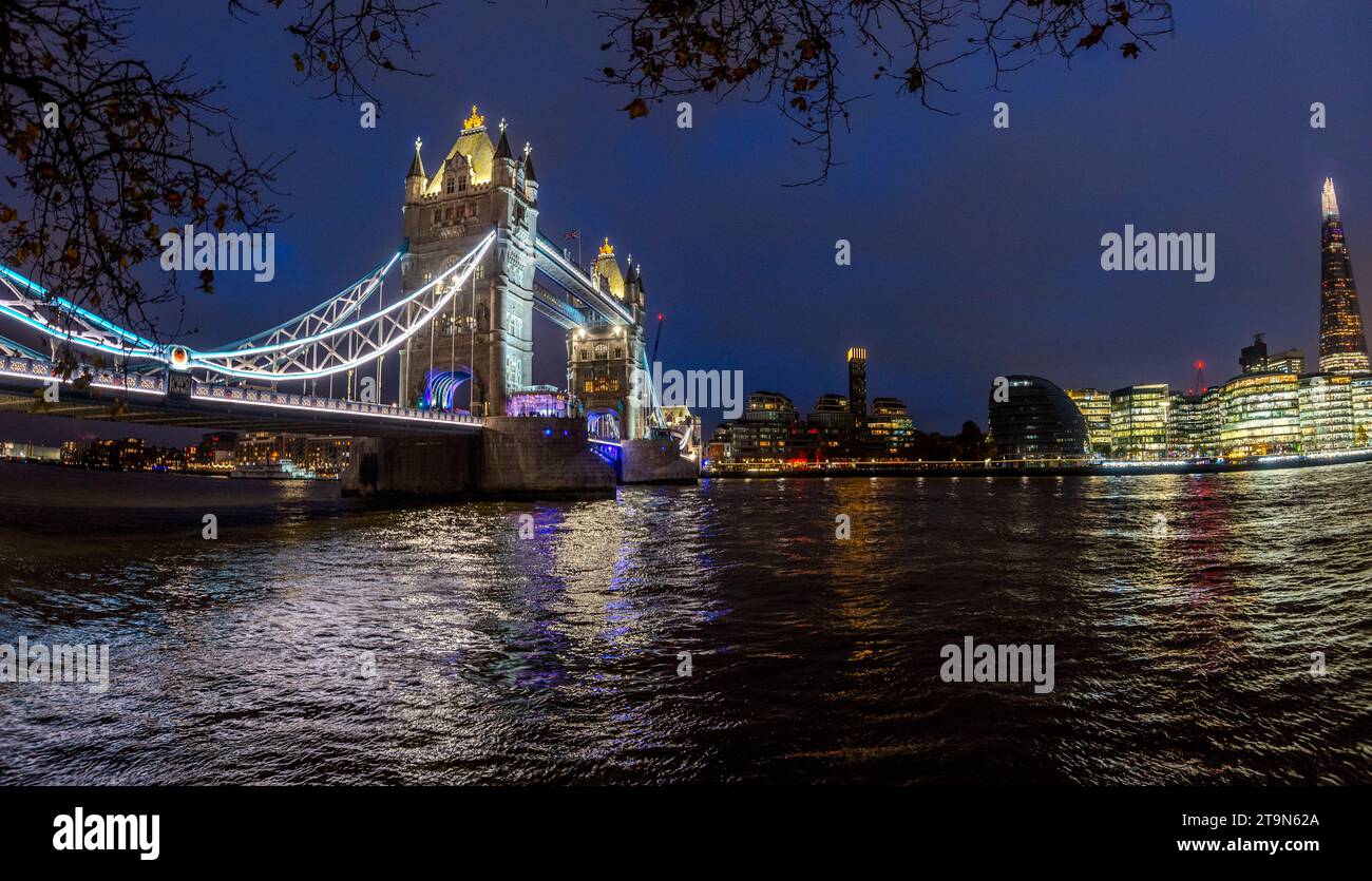 Tower Bridge spanning the Thames as the night draws in on a November ...