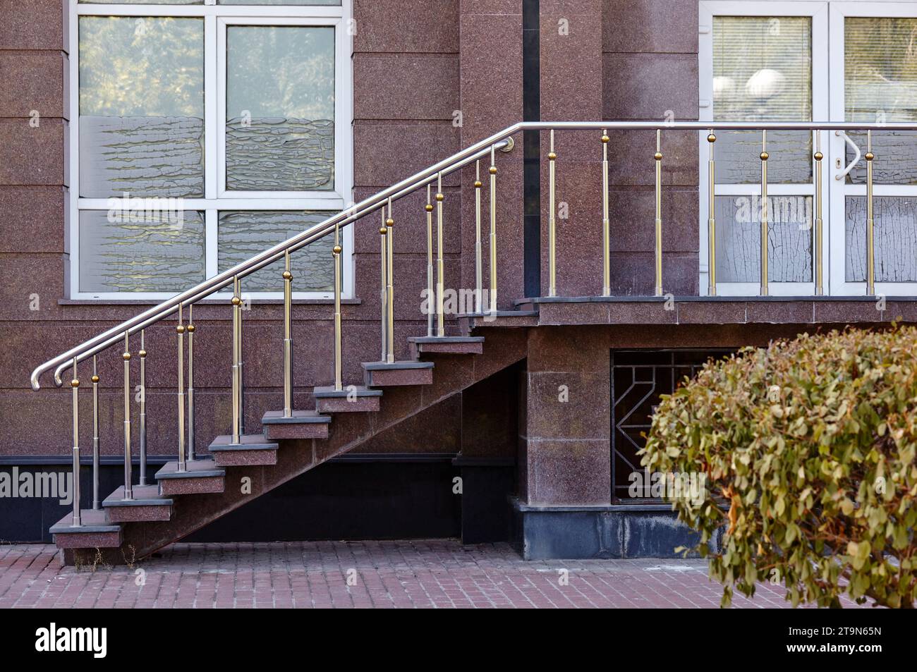 Threshold with steps with an iron fence of twigs. Marble wall with ...