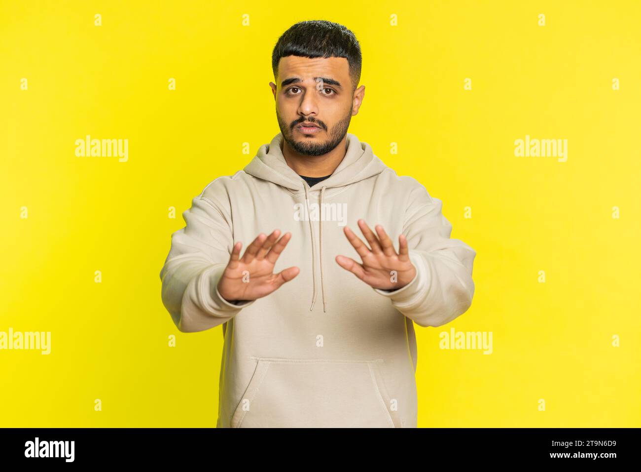 Hey you, be careful. Strict Indian man warning with admonishing hands ...