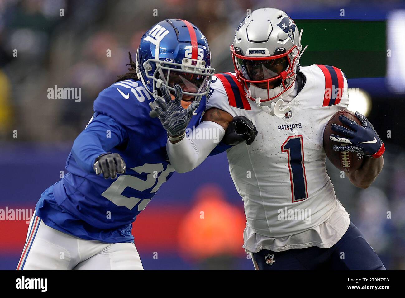 New York Giants cornerback Deonte Banks (25) pushes New England Patriots wide receiver DeVante ...