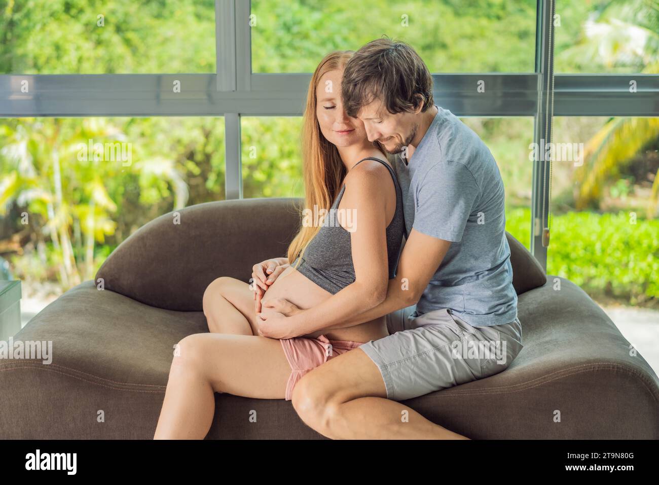 health, pregnancy and happy people concept - husband giving his wife back massage at home Stock ...