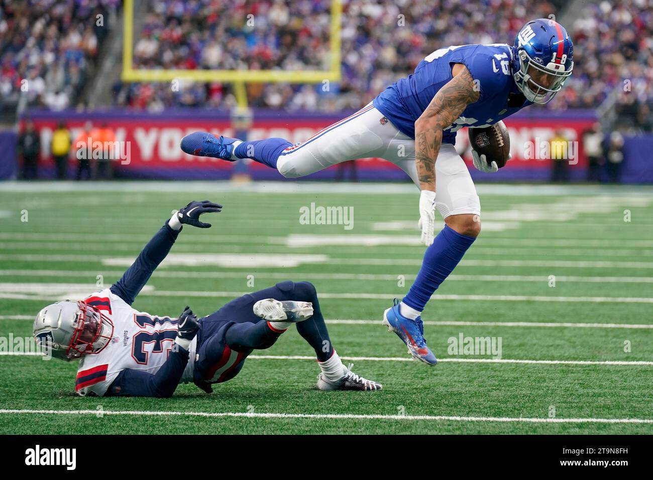 New York Giants wide receiver Isaiah Hodgins (18) avoided a tackle by ...