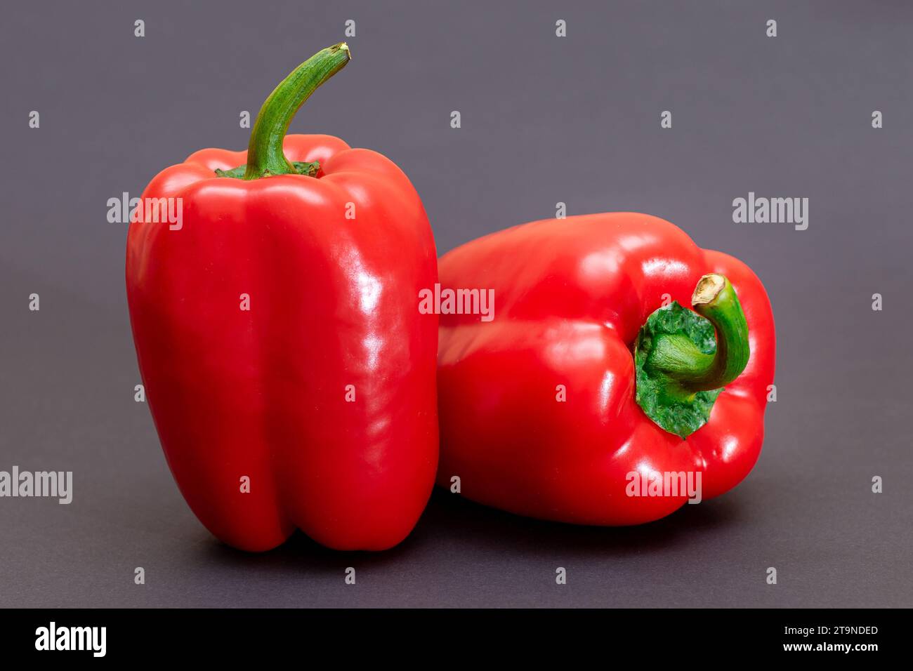 Two Fresh Red Sweet Bell Peppers on Black Background Stock Photo - Alamy
