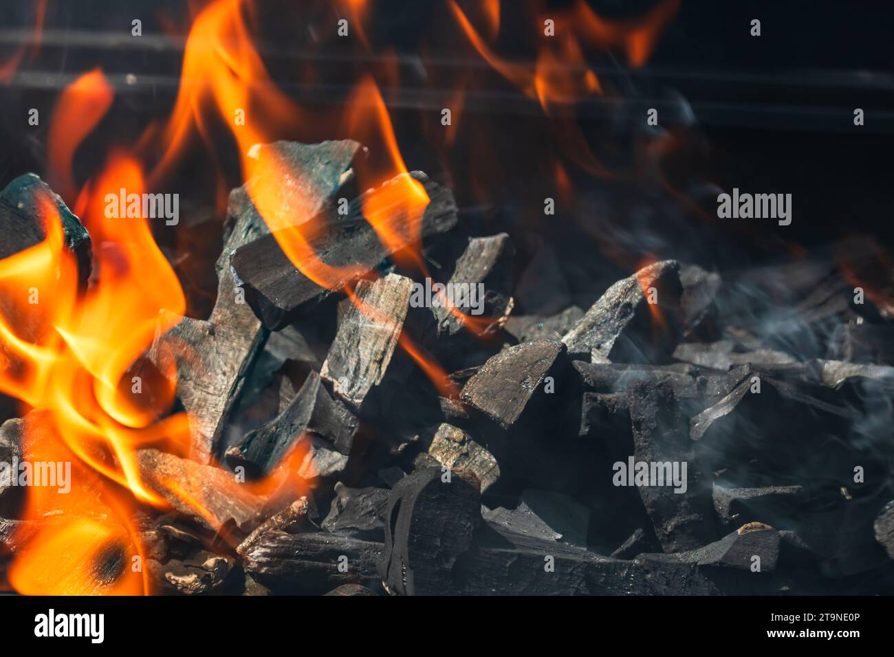 Barbecue grill pit with glowing and flaming hot open fire with red ...