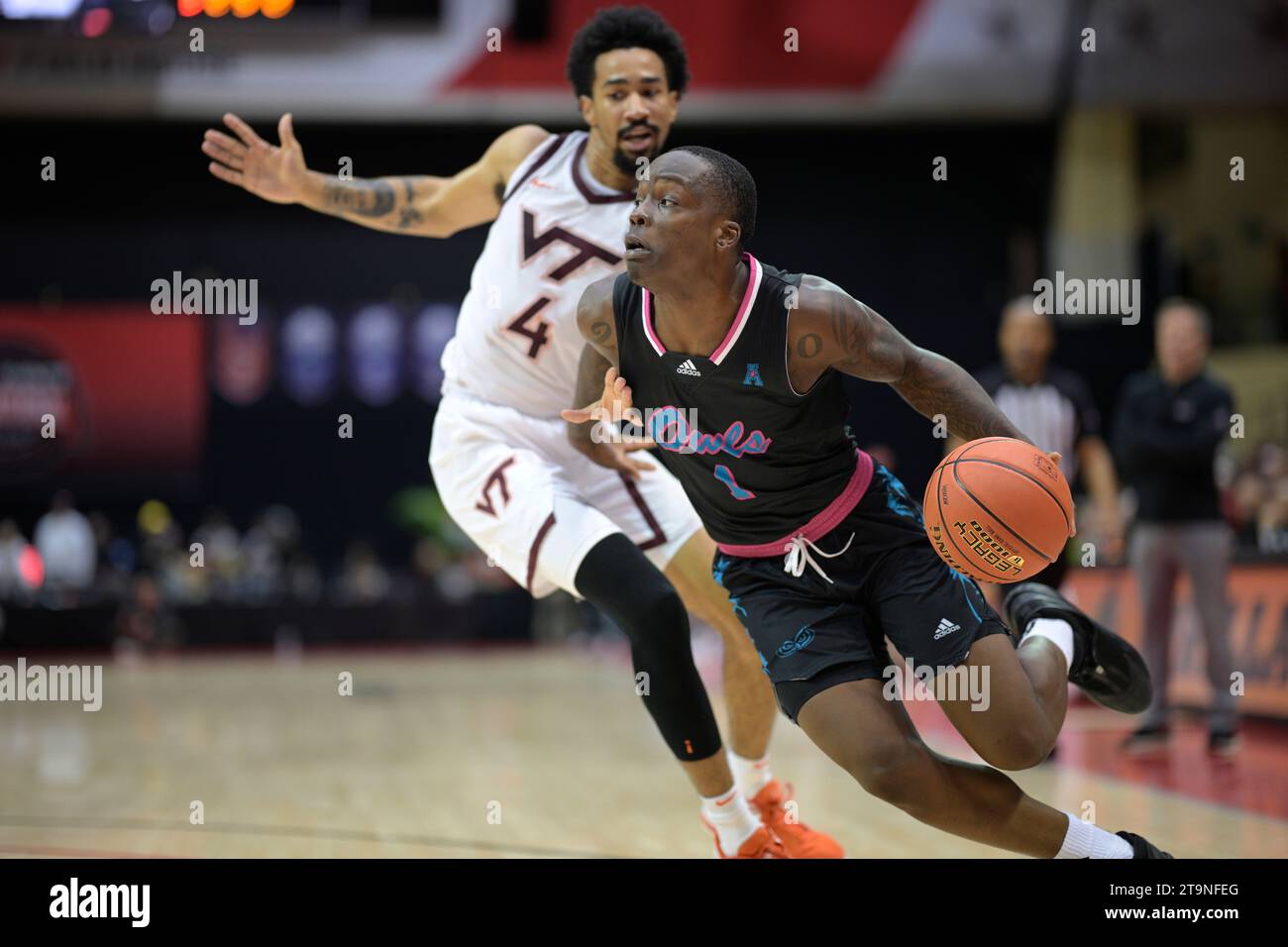 Florida Atlantic guard Johnell Davis (1) drives past Virginia Tech ...