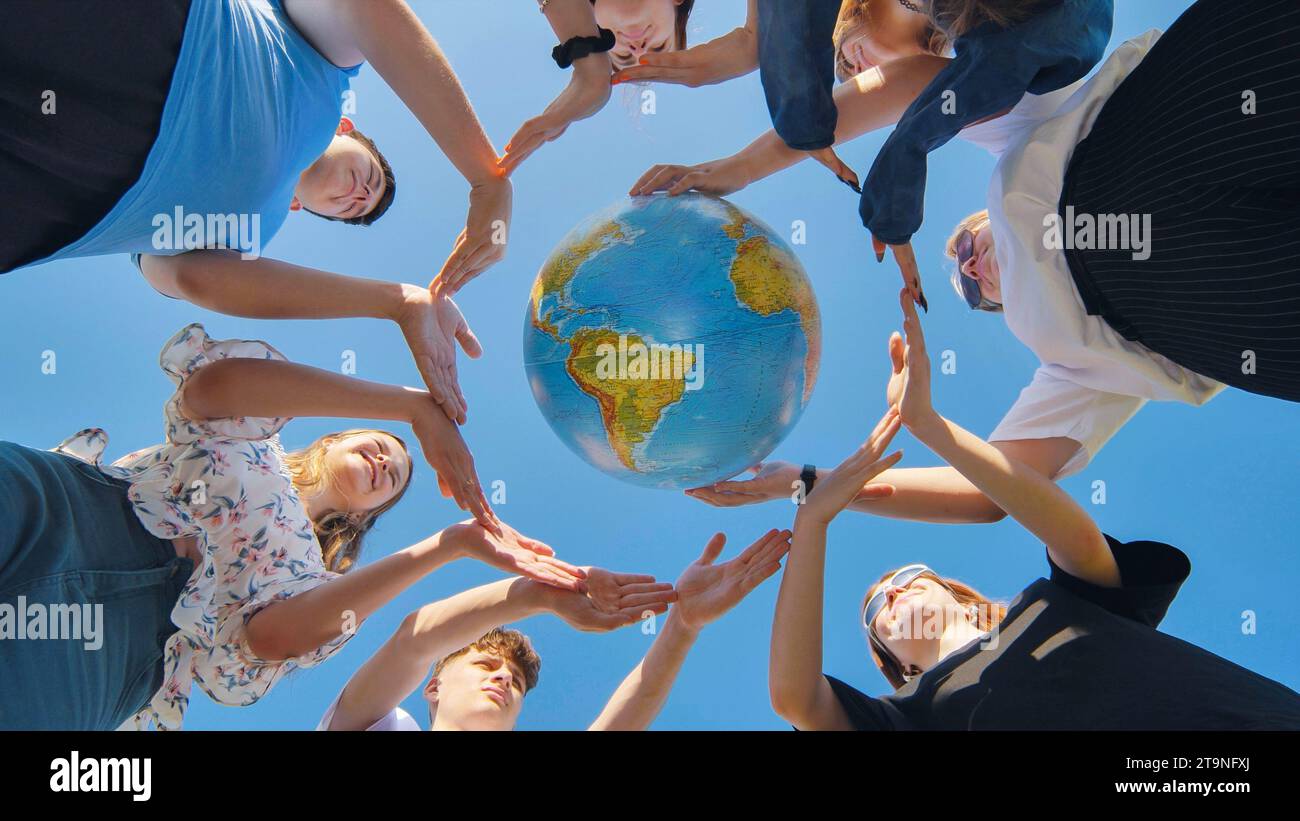 Group of people around a world map hi-res stock photography and images ...