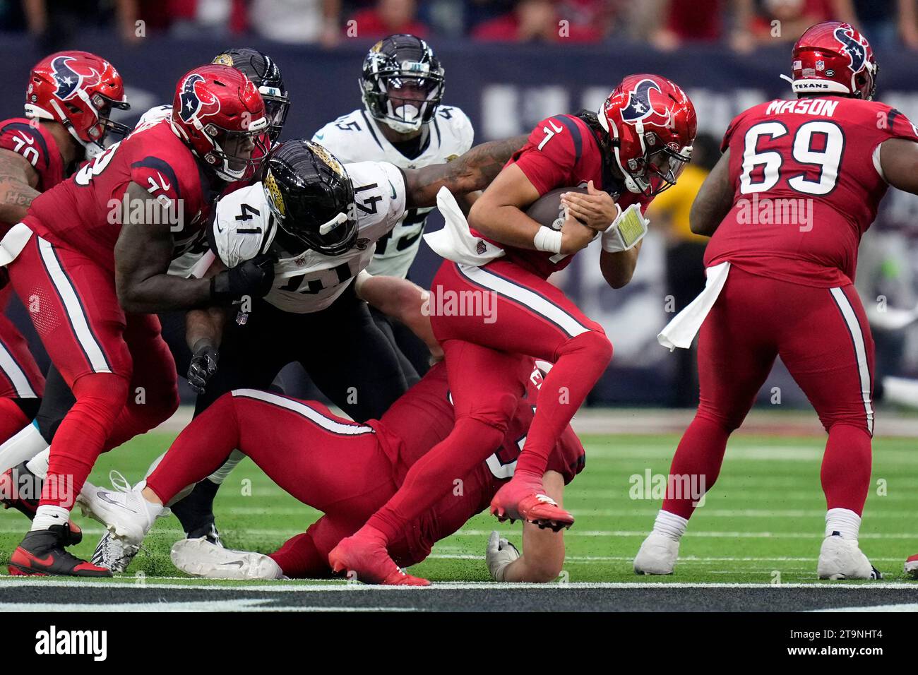Houston Texans quarterback C.J. Stroud (7) works to escape a sack ...