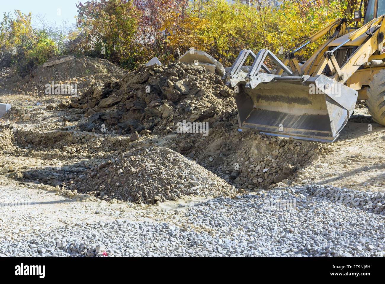 Excavator leveling ground on construction project for highway ...