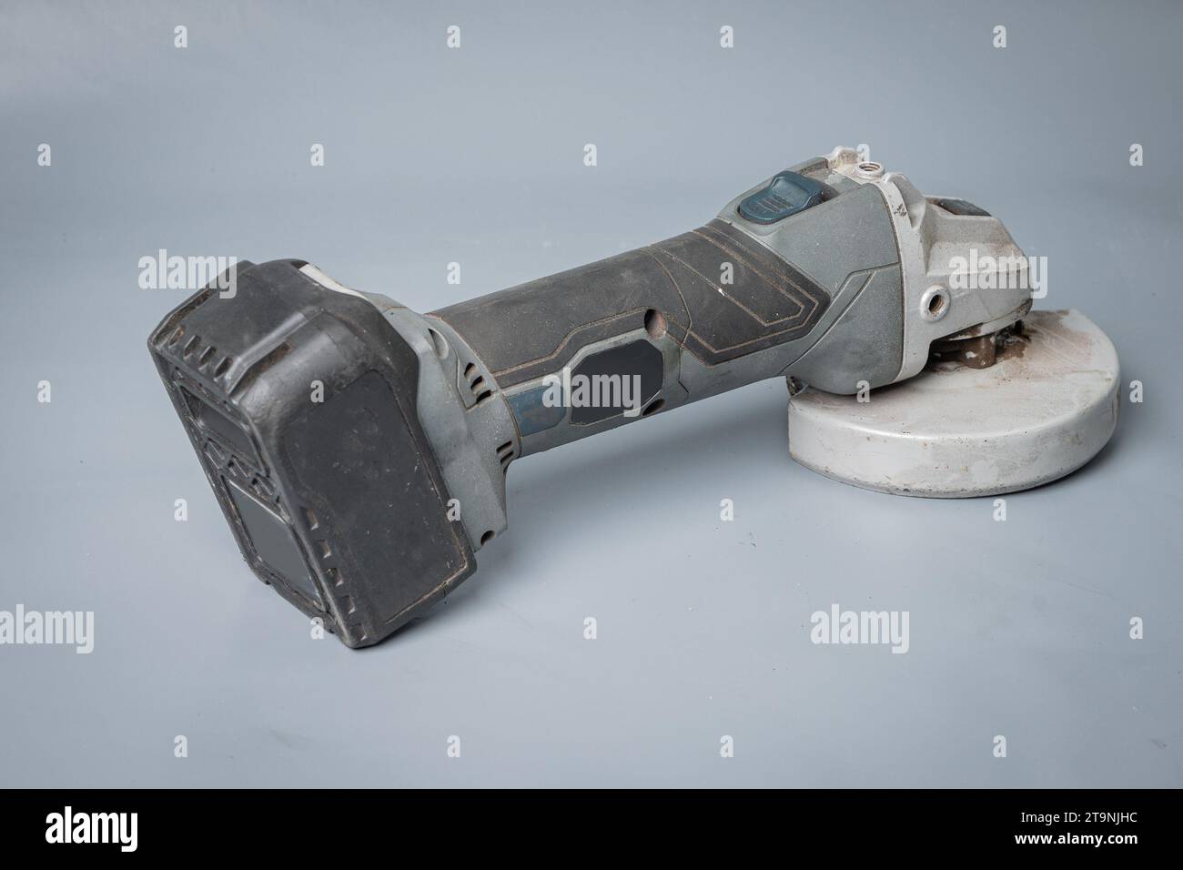 Battery operated angle grinder with grinding abrasive disc mounted ...