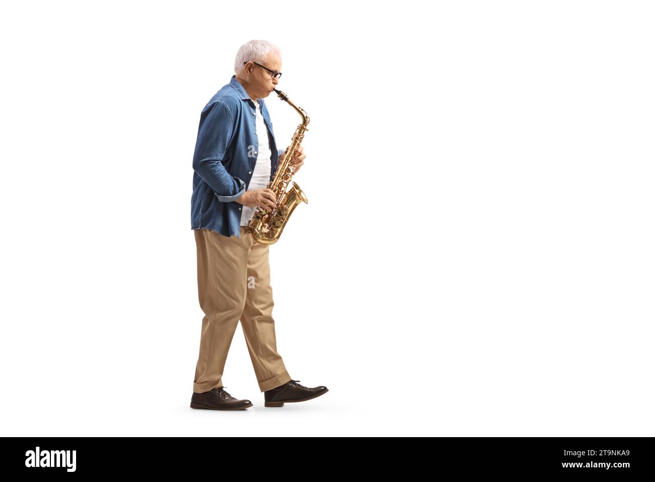 Full length profile shot of a casual man walking and playing a ...