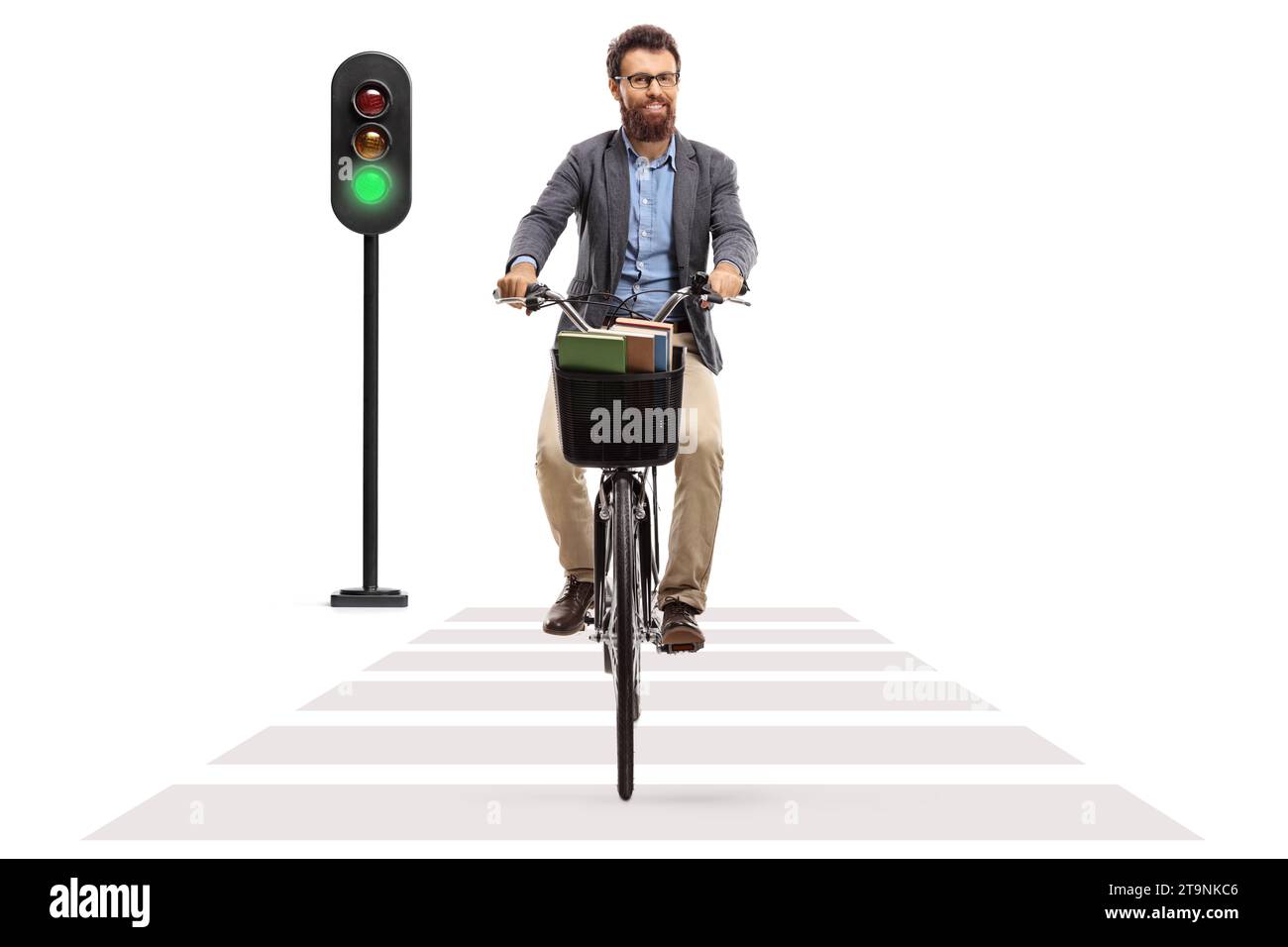Man on a bicycle crossing a street at green traffic light isolated on ...