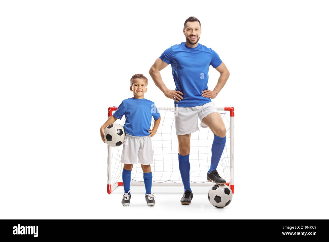Man and boy with football wearing same sports jersey in front of a mini ...