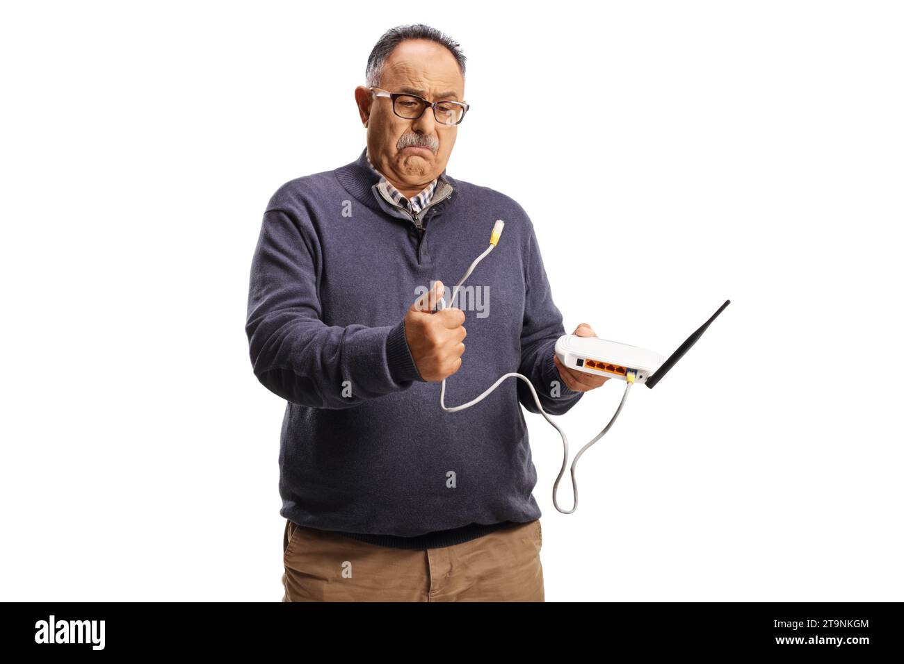 Confused mature man holding a router cable isolated on white background ...