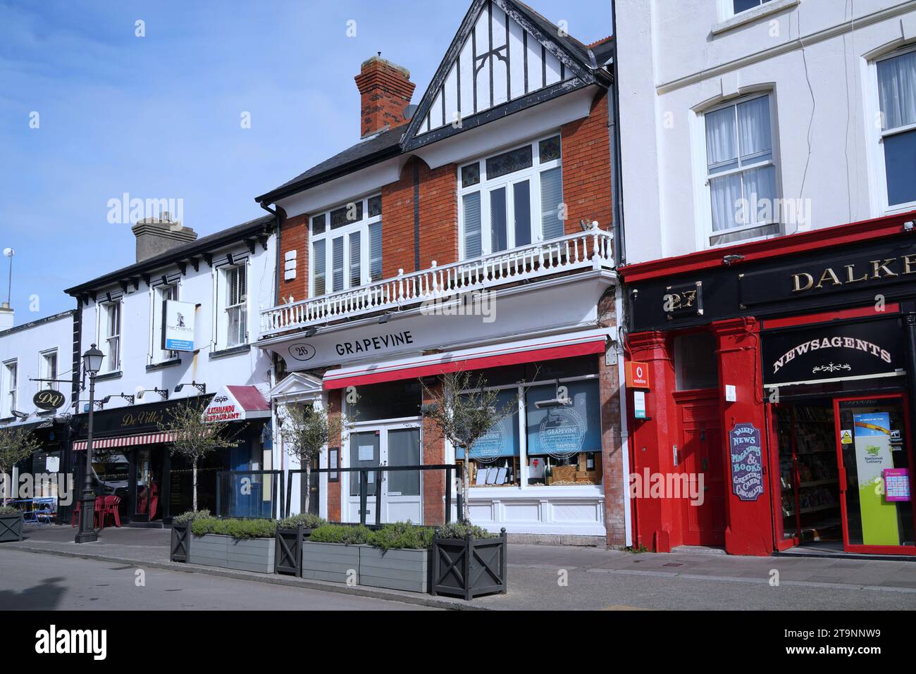 Ireland, small town main street with colorful old shops and restaurants ...