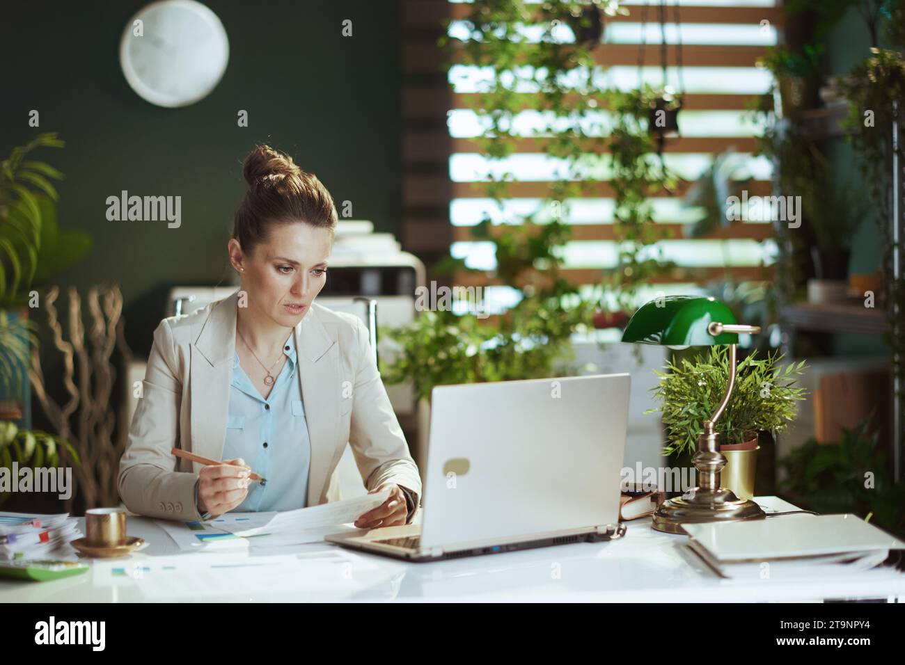 modern small business owner woman in a light business suit in modern ...