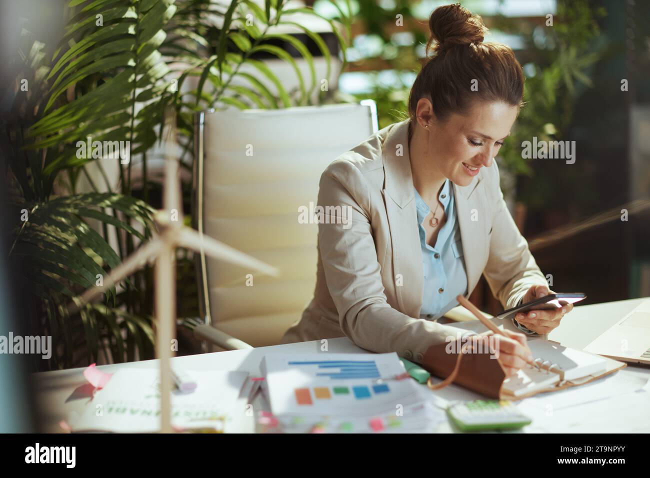 smiling modern 40 years old woman employee in a light business suit in ...