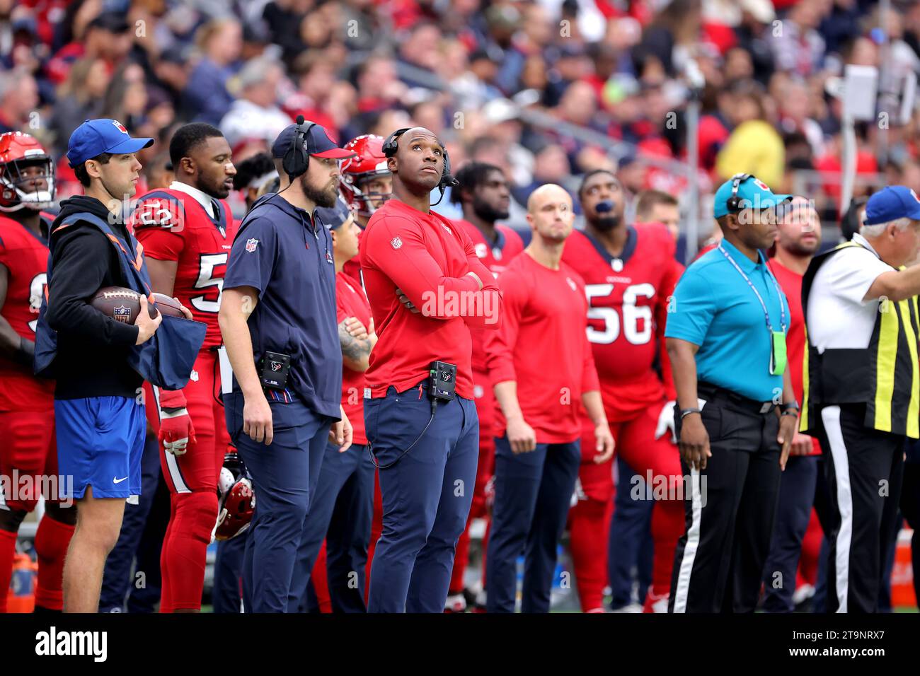 Houston, Texas, USA. 26th Nov, 2023. Houston Texans head coach Demeco Ryans (center) looks up at ...